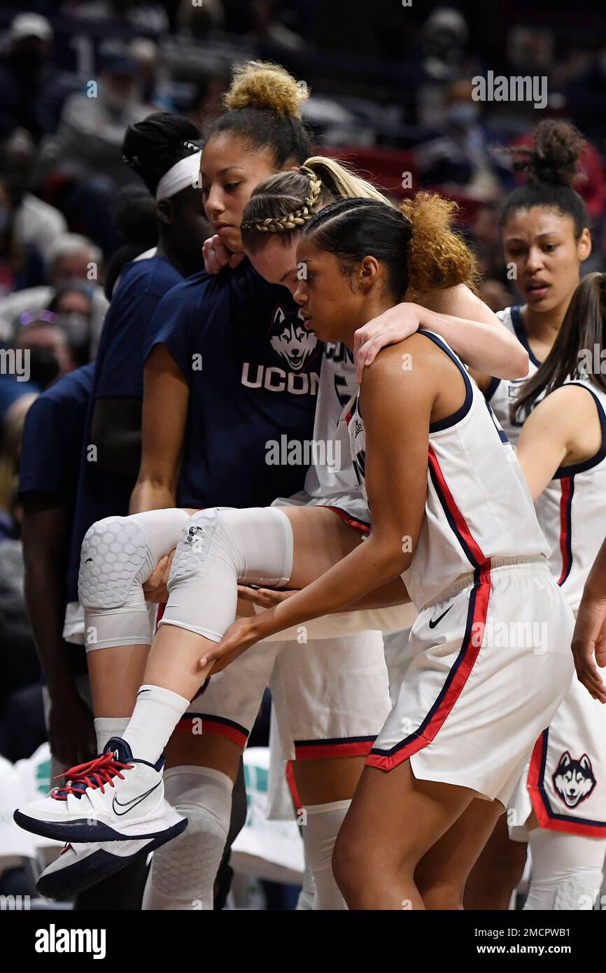 Connecticut's Paige Bueckers, center, is helped off the court by Amari ...