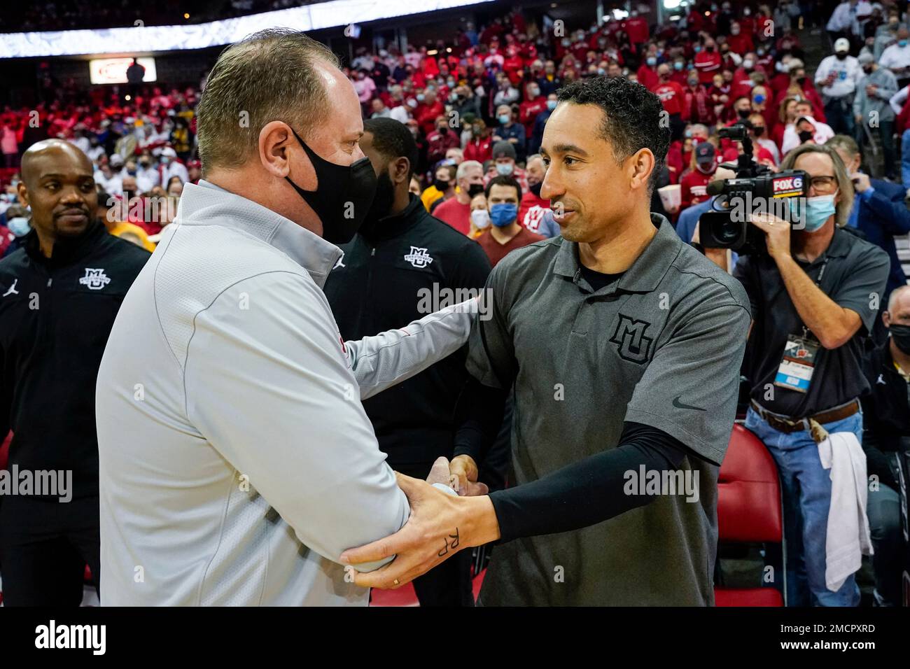 Wisconsin head coach Greg Gard, left, and Marquette head coach Shaka ...