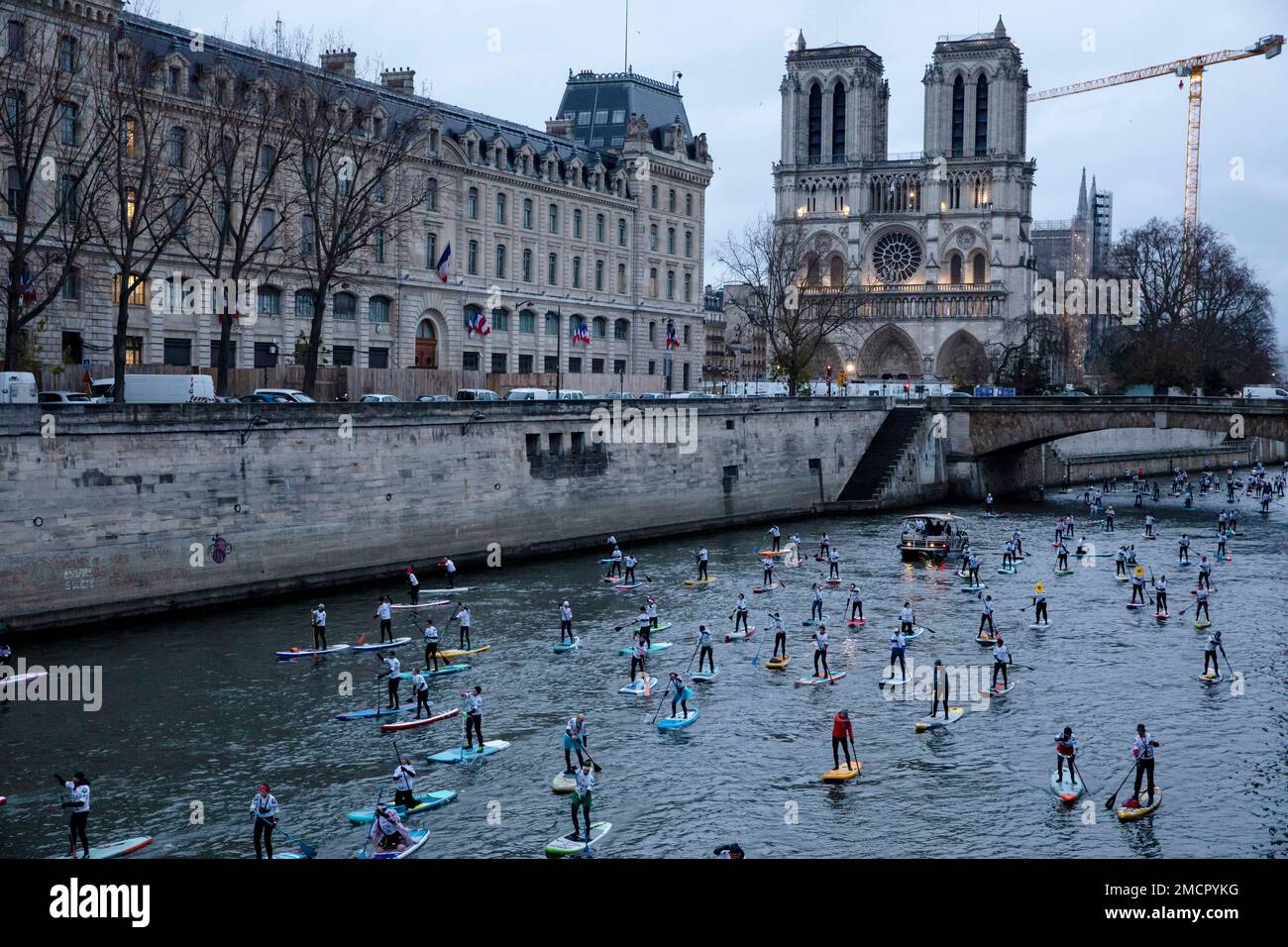 Competitors steer their Stand Up Paddle boards past Notre Dame ...