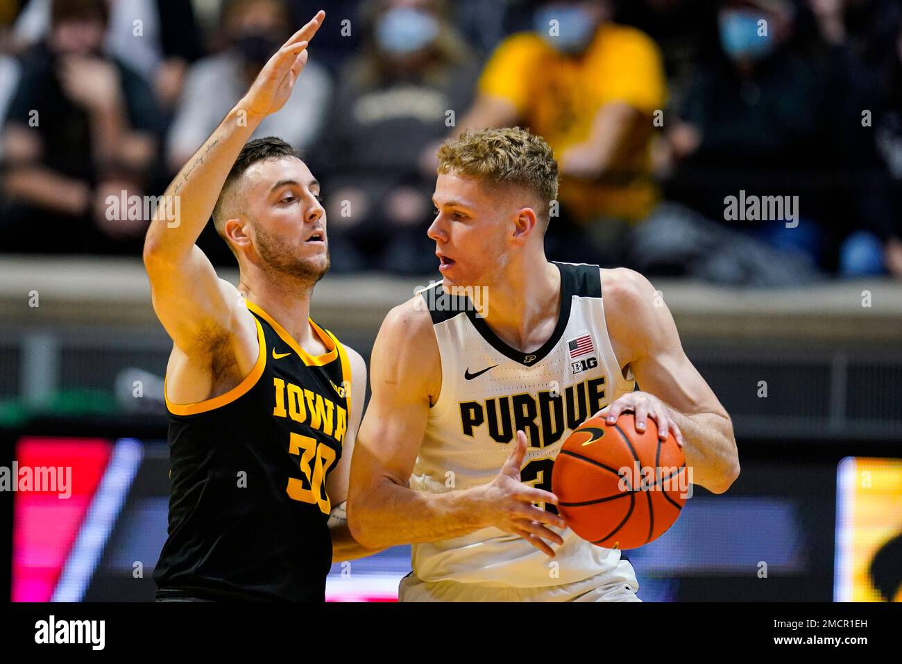 Iowa guard Connor McCaffery (30) defends Purdue forward Caleb Furst (3 ...