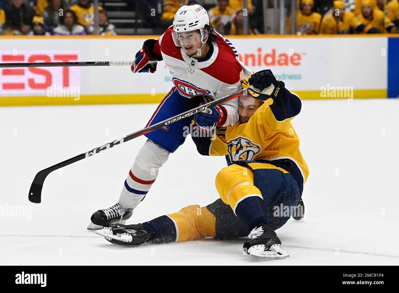 Nashville Predators center Luke Kunin, right, collides with Montreal ...