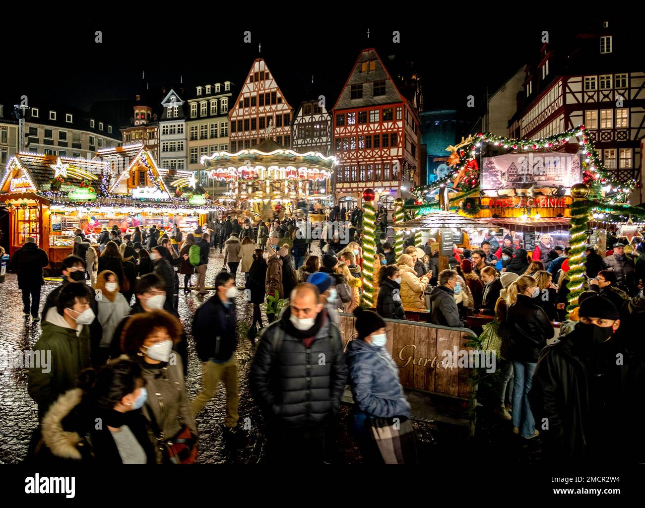 People wear face masks as they visit the traditional Christmas market ...