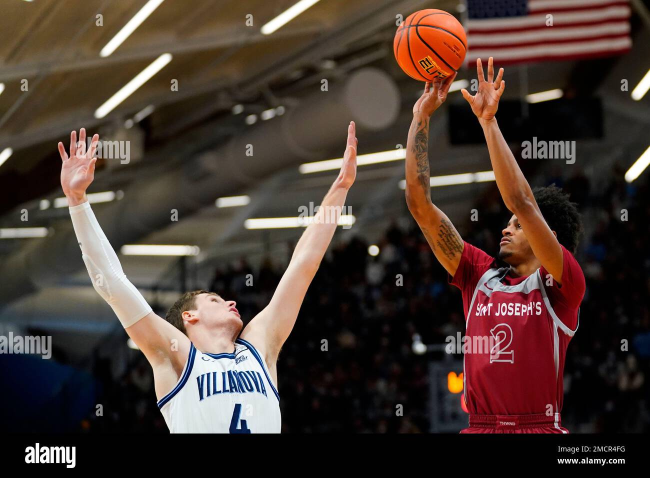 Saint Joseph's Erik Reynolds II, right, goes up for a shot against ...