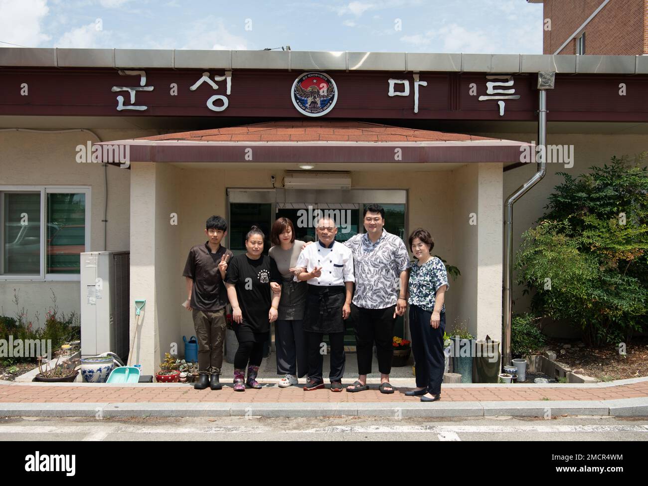 Gun Sung Maru workers smile in front of their restaurant at Kunsan Air ...