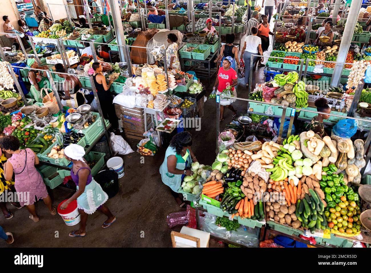Stalls with fresh fruit and vegetables for sale at busy indoor food ...