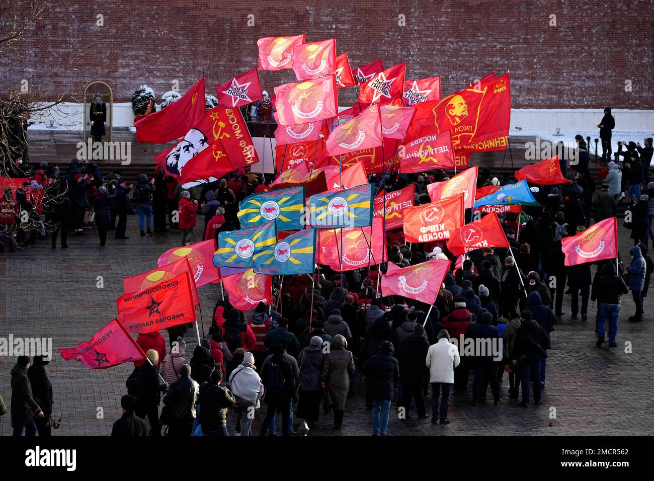 Communist party supporters hold red flags attend a wreath-laying ...