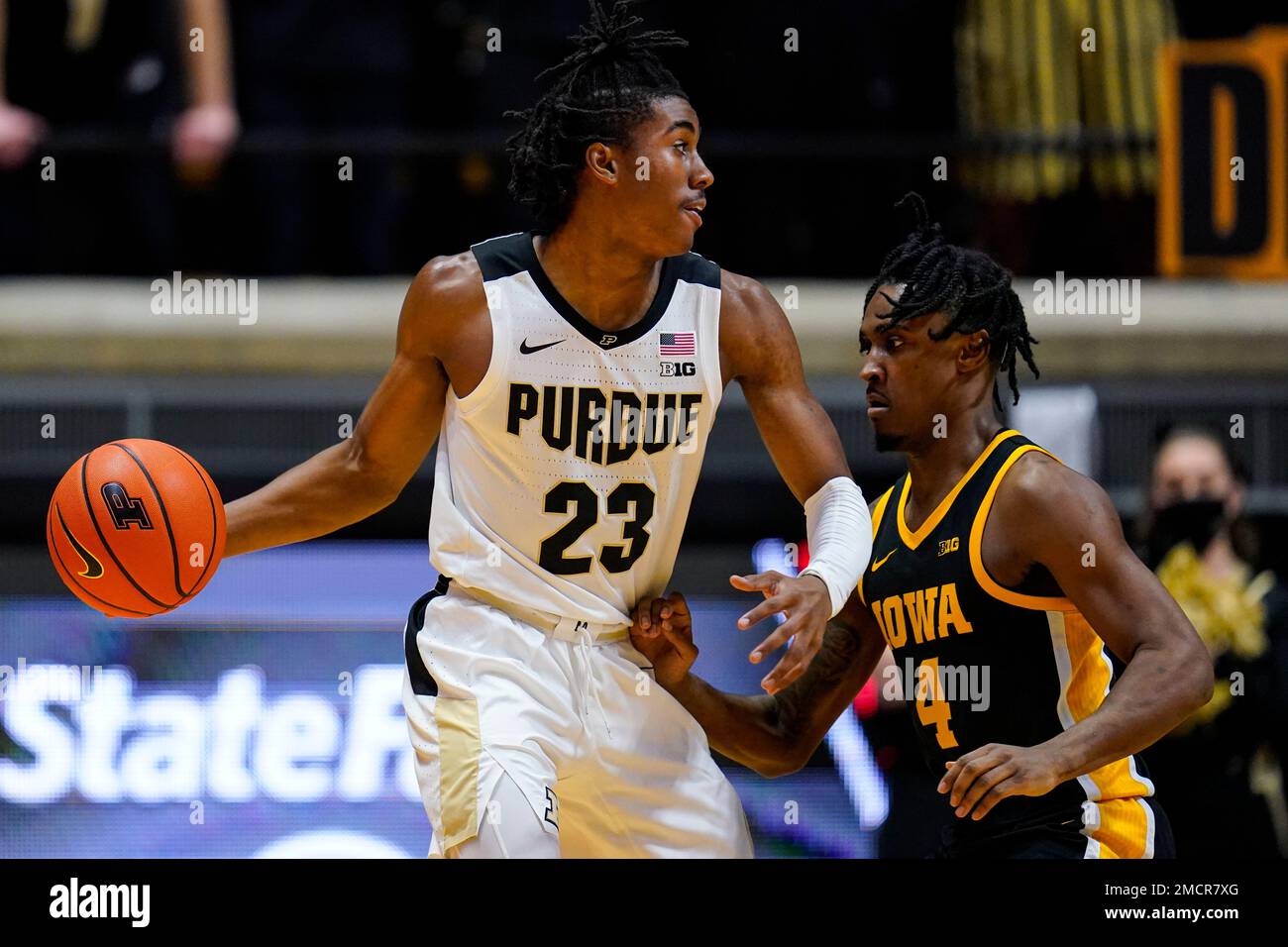 Purdue guard Jaden Ivey (23) is defended by Iowa guard Ahron Ulis (4 ...