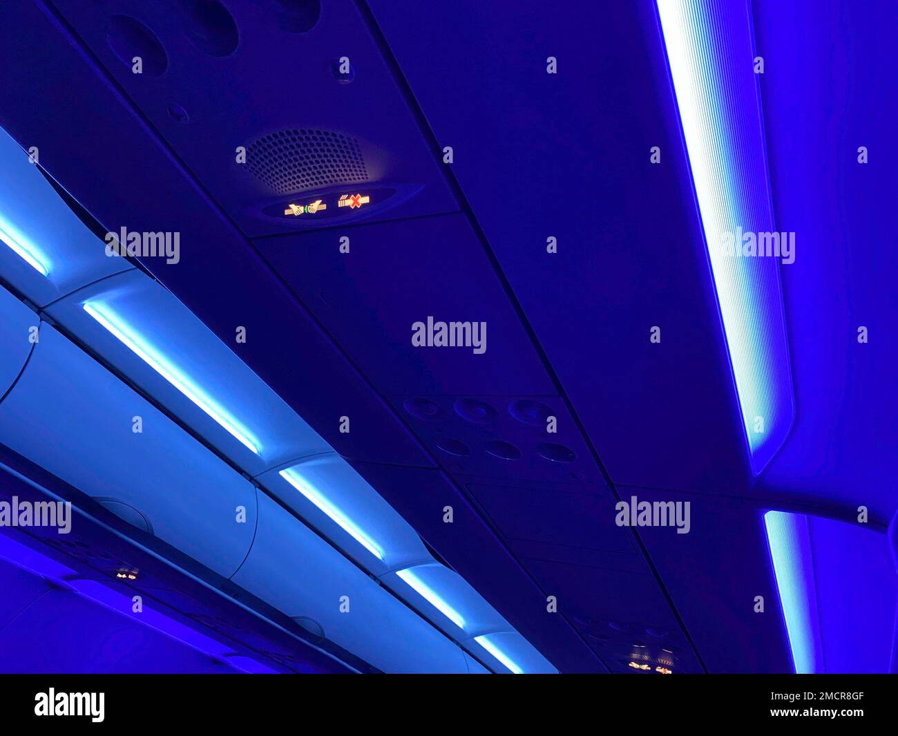 Airplane ceiling at night. No Smoking and Fasten Seat belt Sign Inside ...