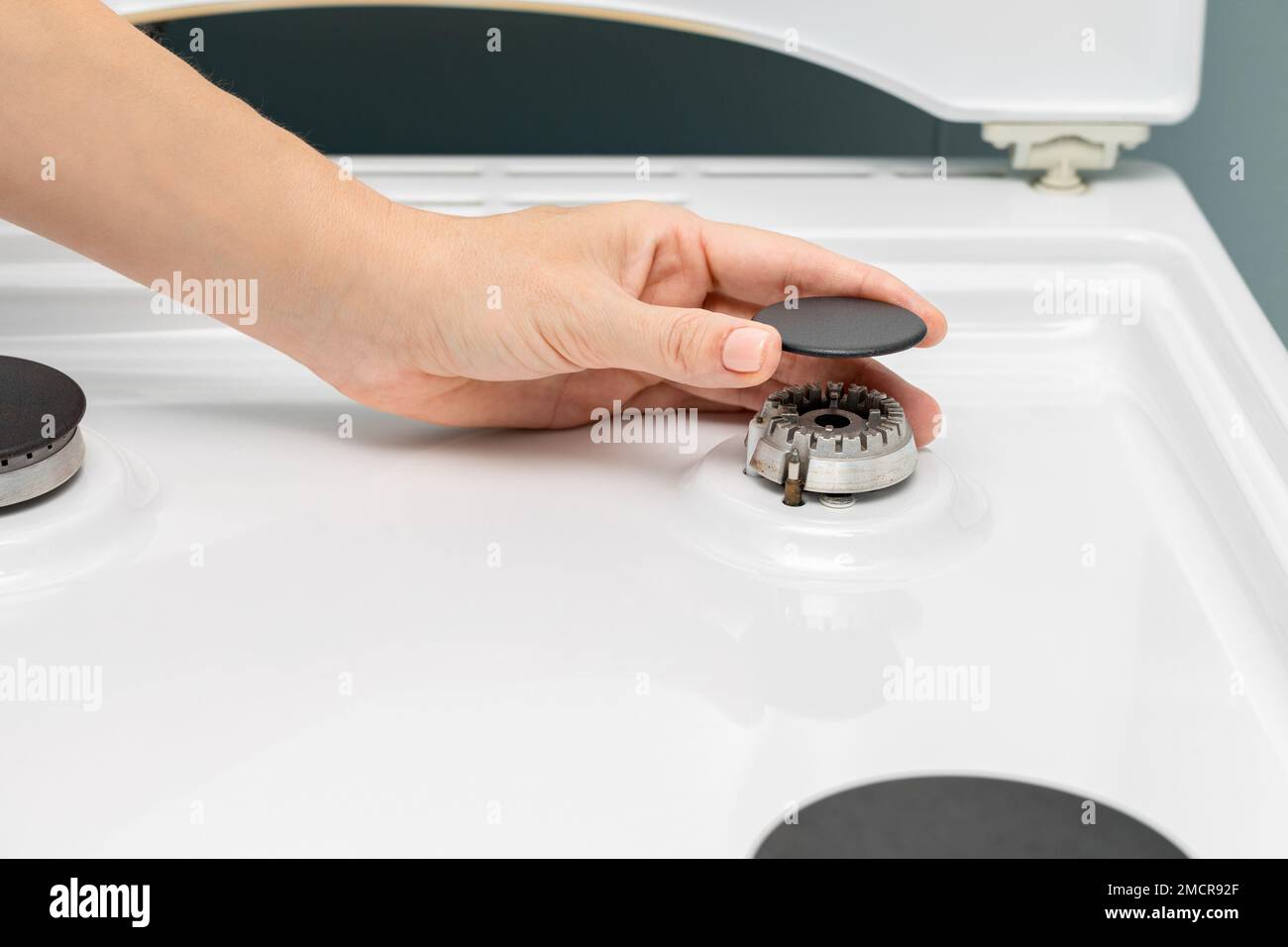 man repairing gas stove in the kitchen. woman washing the stove in the ...