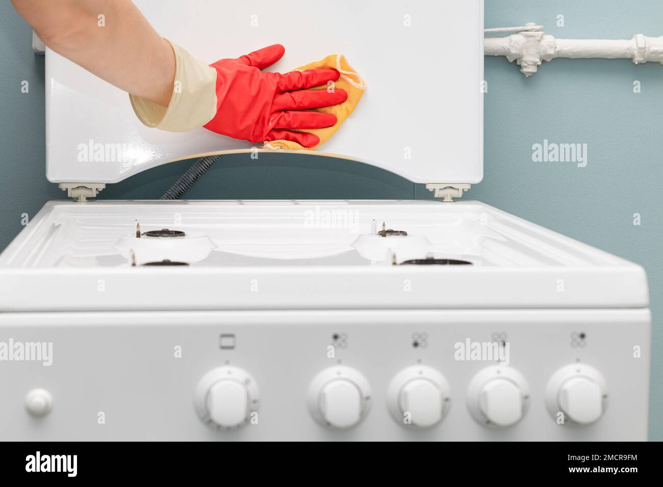 man washing the oven in the kitchen. woman cleaning gas stove. man ...