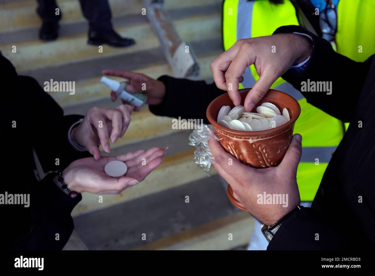 A pilgrim receives communion bread wafers during a Holy mass by Pope ...