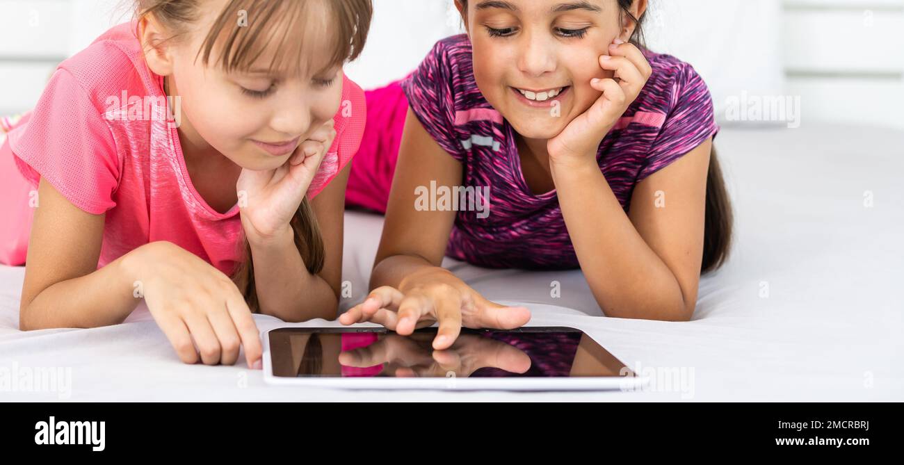 Little girls using tablet computer as art board - painting together ...