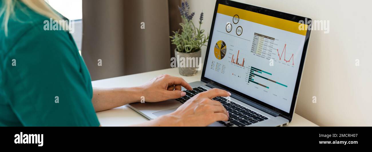 businesswoman analyzing statistics on laptop screen, working with ...