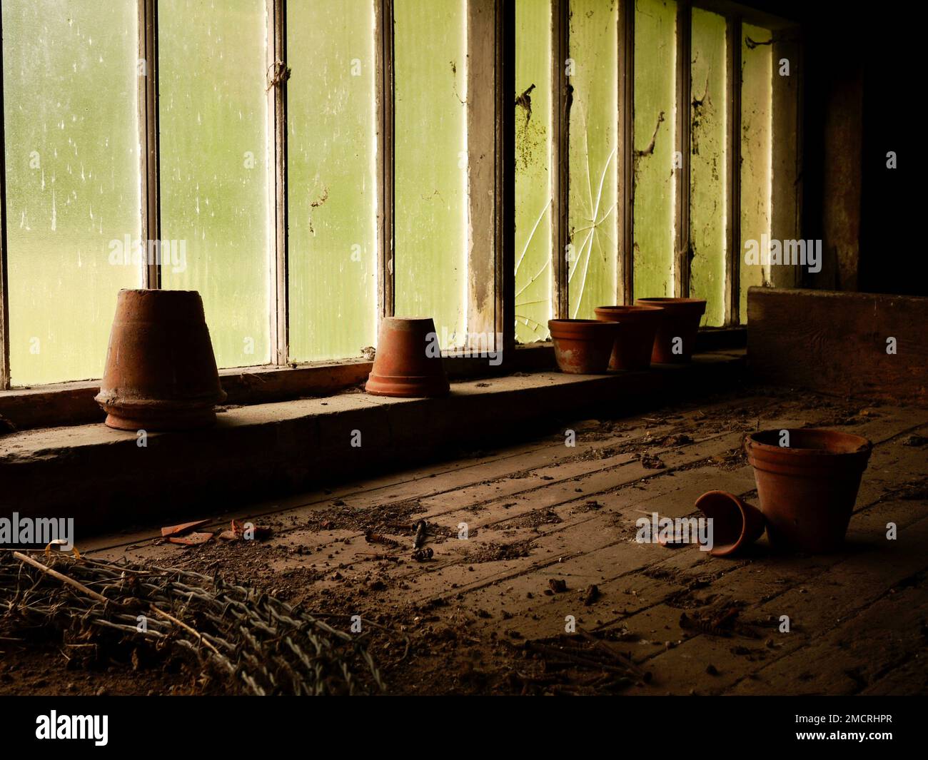 An atmospheric image of dusty terracotta pots in an old abandoned ...