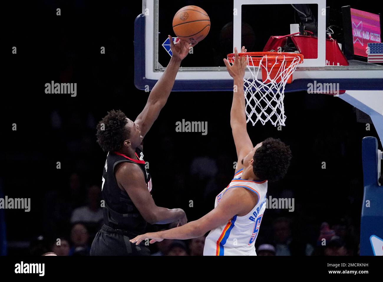 Houston Rockets forward Jae'Sean Tate, left, shoots in front of ...