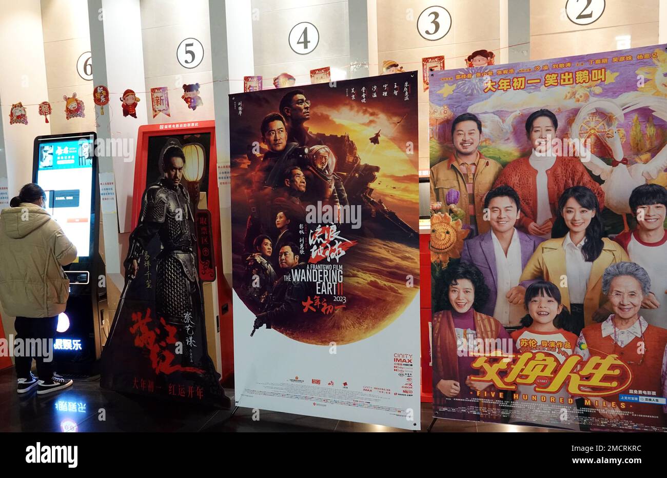 YICHANG, CHINA - JANUARY 22, 2023 - People walk past posters of Chinese ...