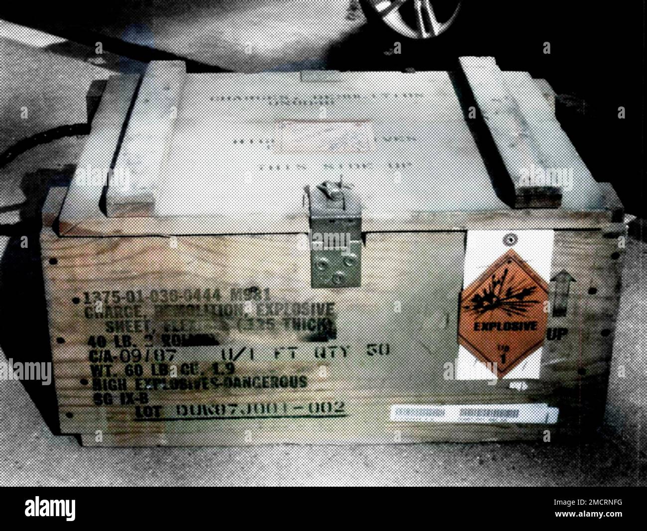 A photo illustration of a crate containing stolen military explosives ...
