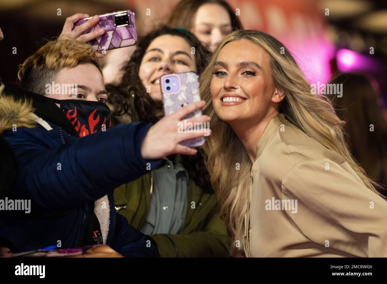 Perrie Edward of Little Mix poses for a selfie with fans upon arrival ...