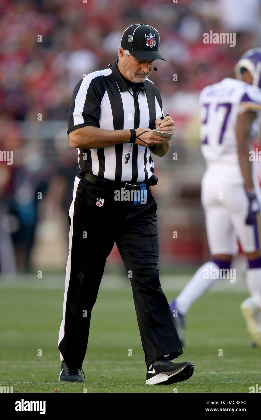 Umpire Carl Paganelli (124) makes a note during an NFL football game ...