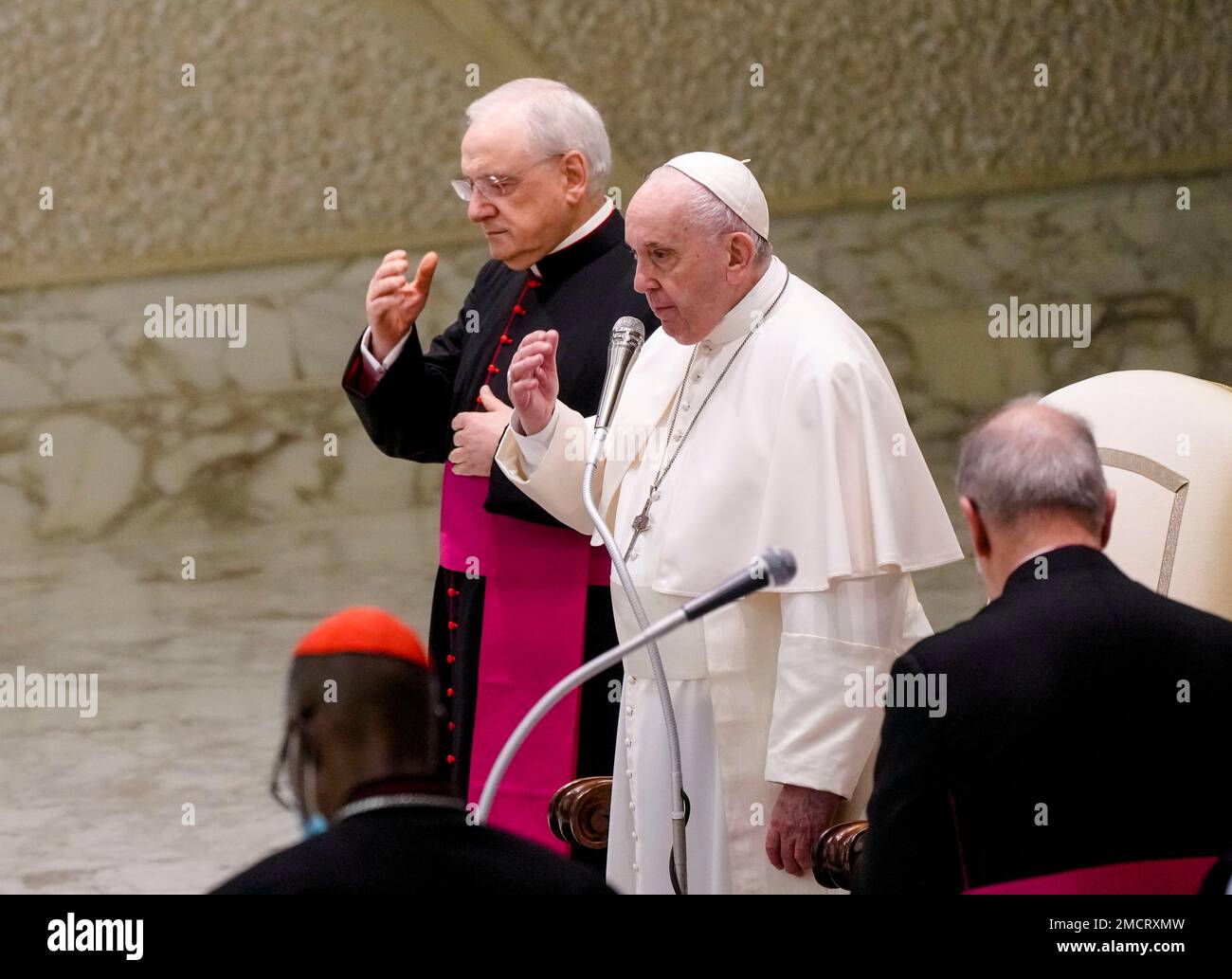 Pope Francis, with Monsignor Leonardo Sapienza, left, makes the sign of ...