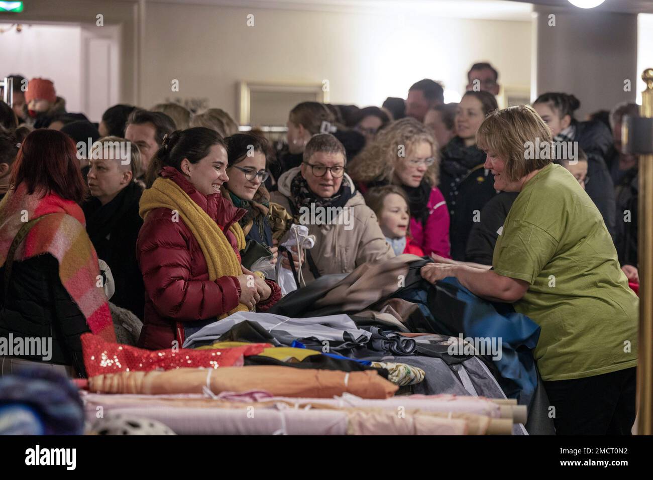 Dresden, Germany. 22nd Jan, 2023. Interested parties look at the range of fabrics on offer at ...
