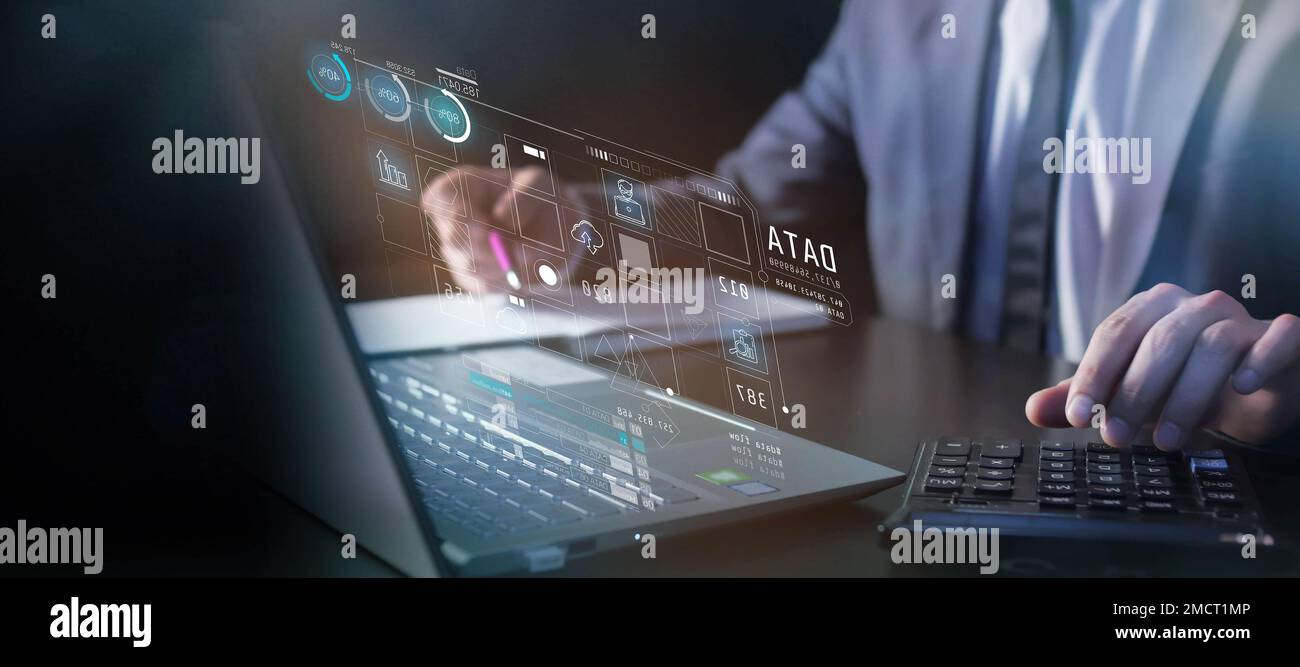 Businessman working with table of corporate data Stock Photo - Alamy