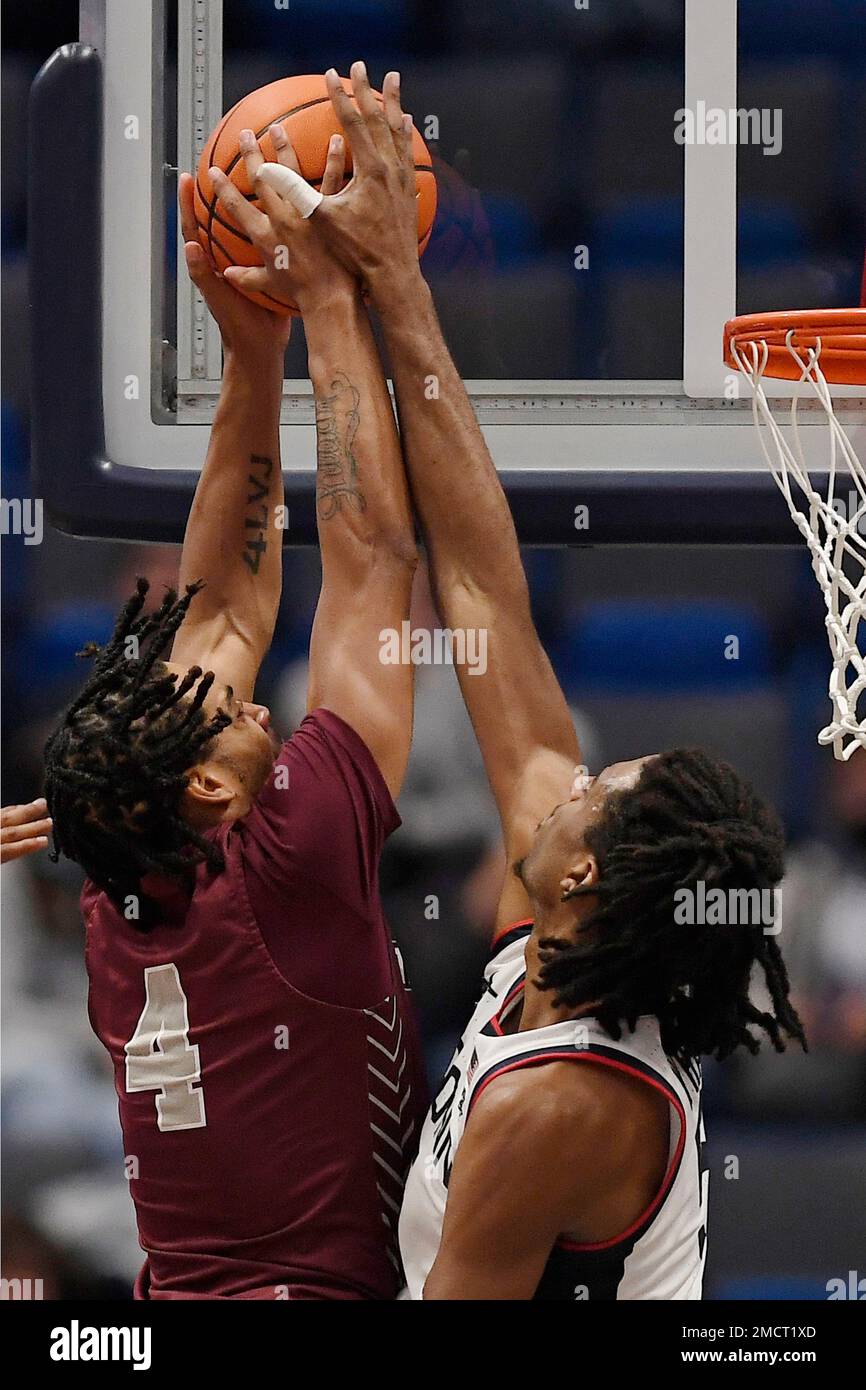 Connecticut's Isaiah Whaley, right, stops a shot attempt by Maryland ...