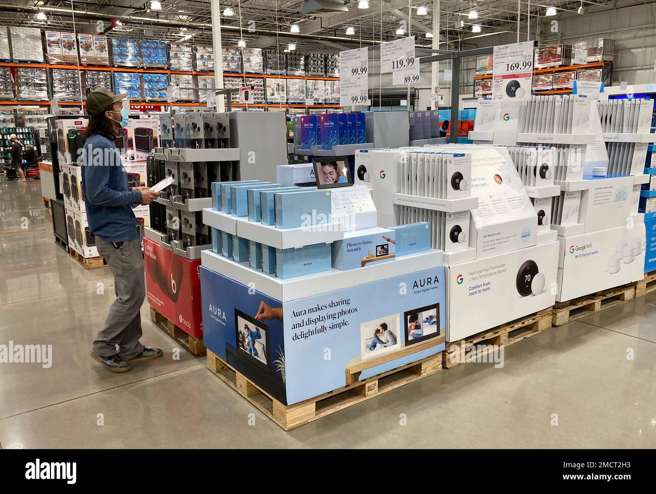 A shopper peruses a display of items in the electronics section of a ...