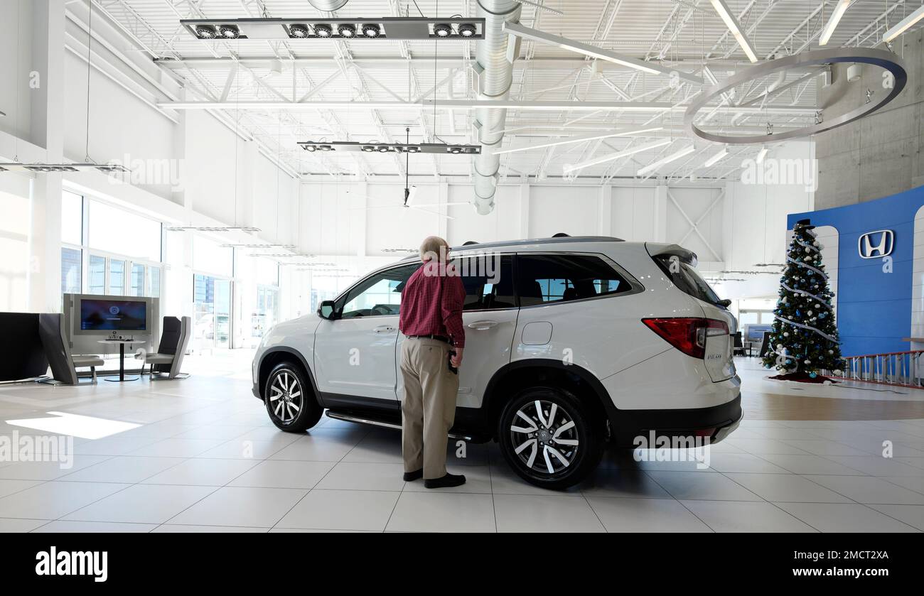 A prospective buyer looks over a 2022 Pilot sports-utility vehicle on ...