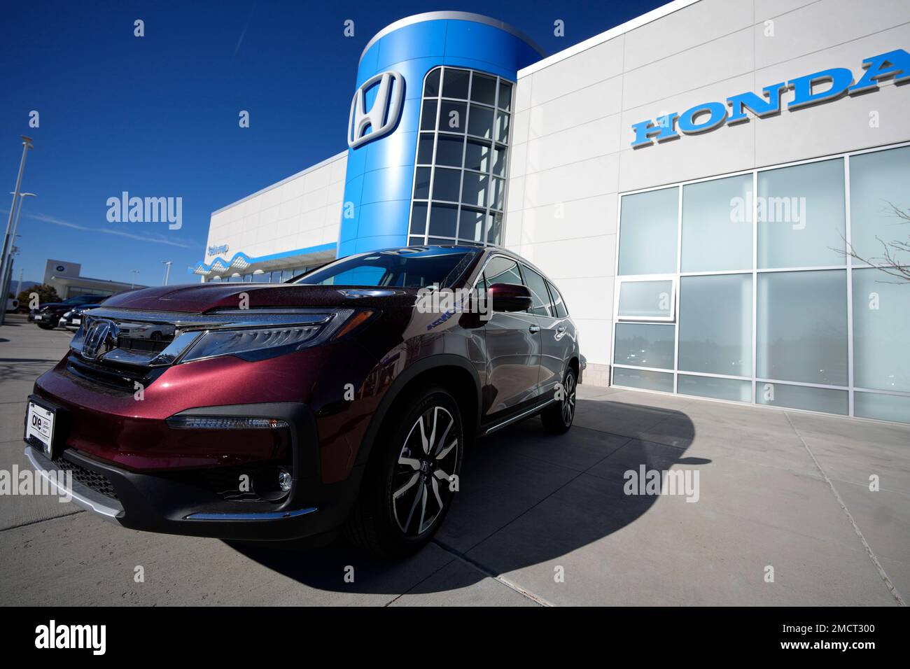 A 2022 Pilot sits in front of a Honda dealership Tuesday, Nov. 30, 2021 ...