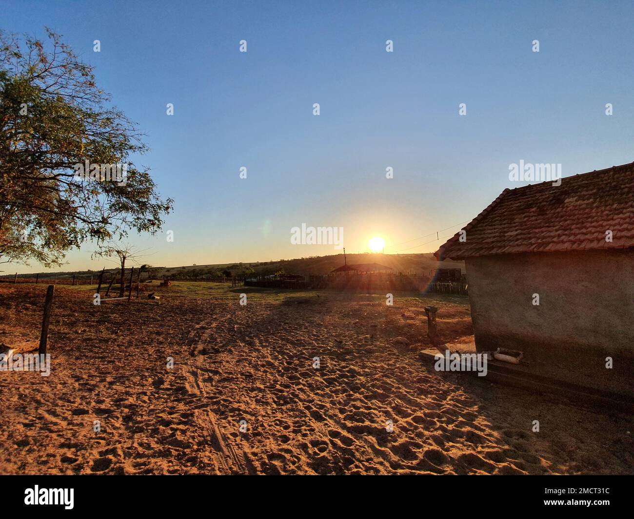Countryside rural sunset view with a house Stock Photo - Alamy