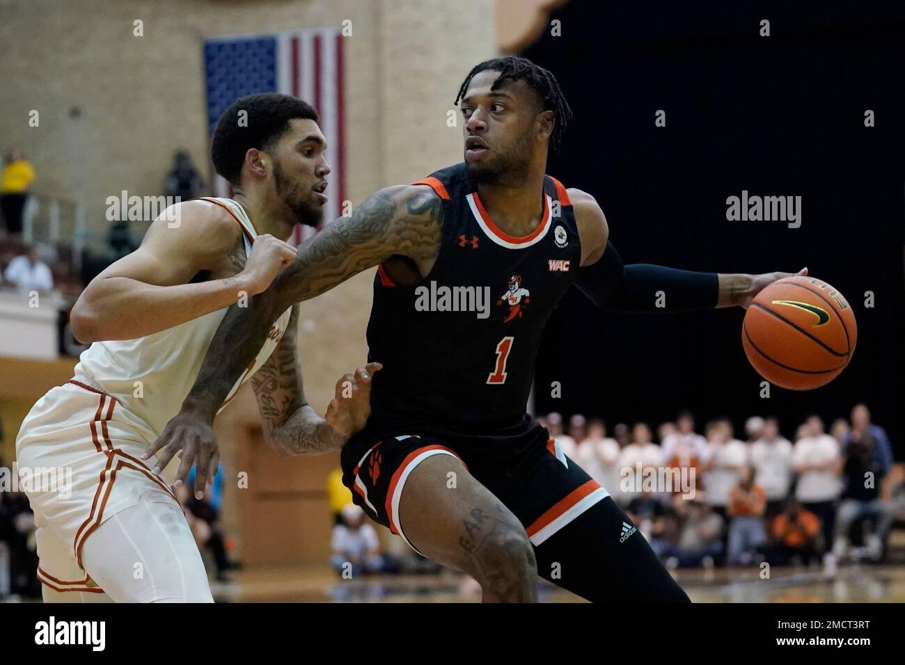 Sam Houston State guard Savion Flagg (1) drives around Texas forward ...
