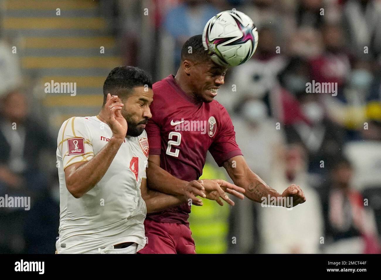 Qatar's Pedro Miguel, right, jumps for a header with Bahrain's Sayed ...