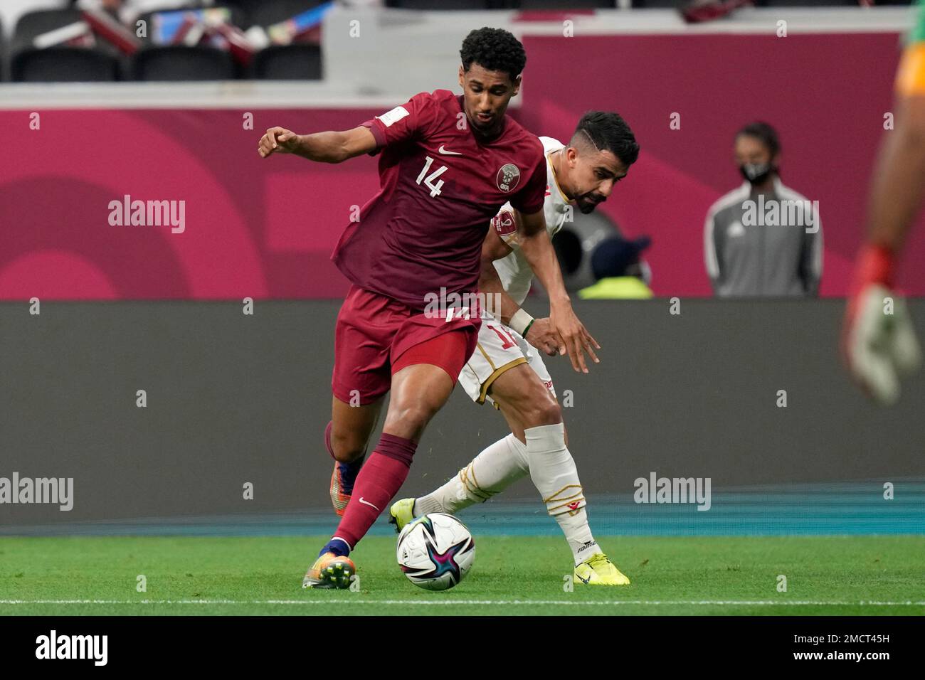 Qatar's Homam Ahmed, left, is challenged by Bahrain's Sayed Redha ...