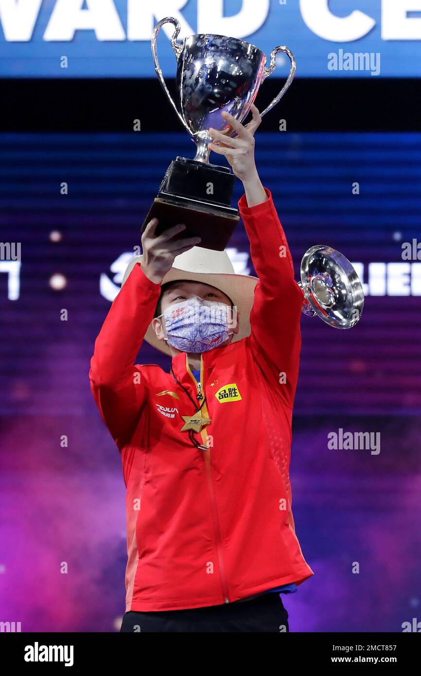 China's Zhendong Fan lifts the trophy and the lids falls off during the ...