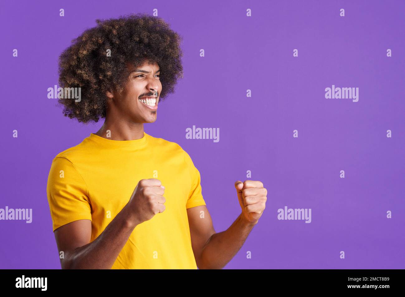 Happy african man celebrating raising the fists Stock Photo - Alamy