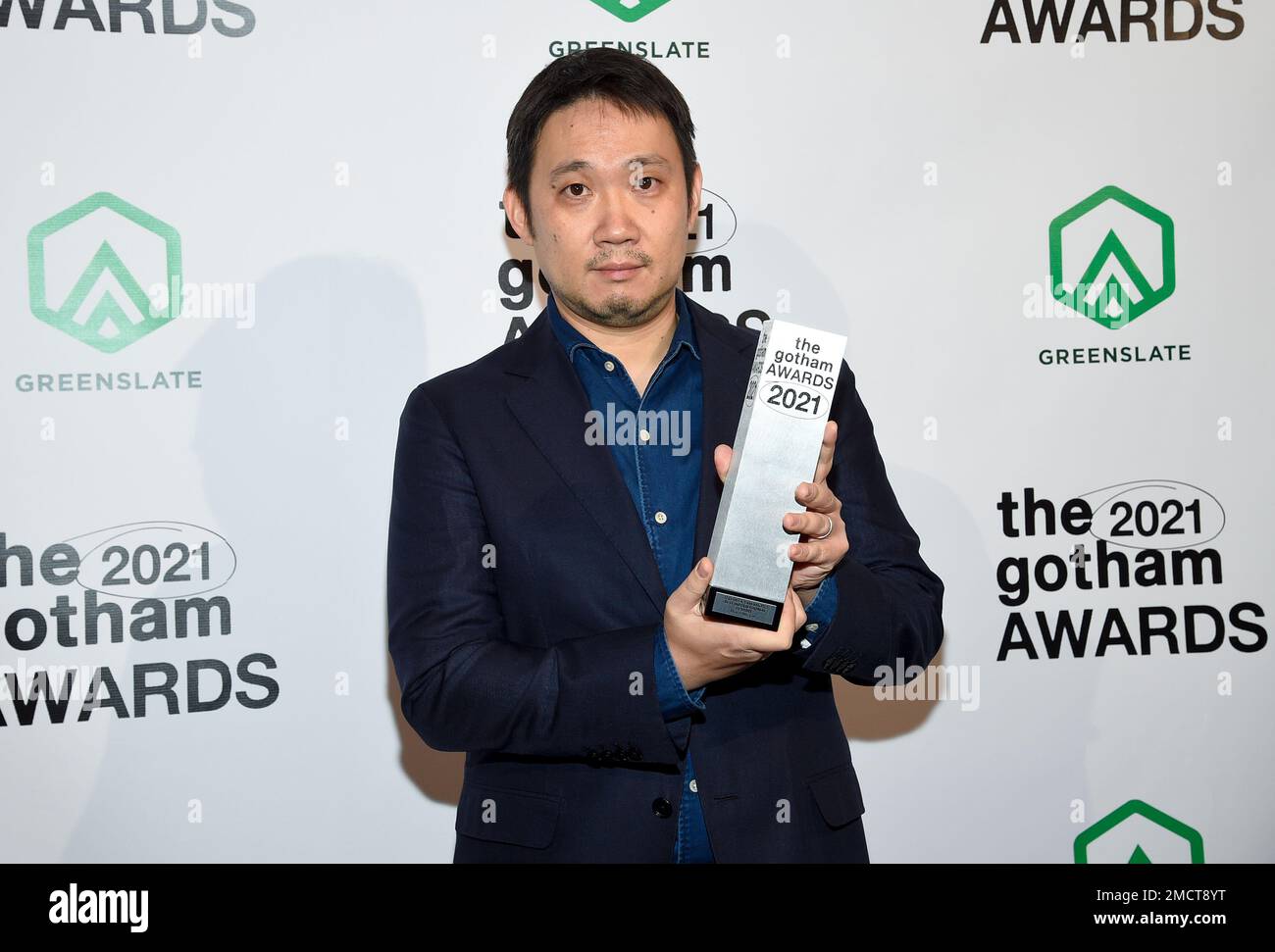 Japanese director Ryusuke Hamaguchi poses with the award for best ...