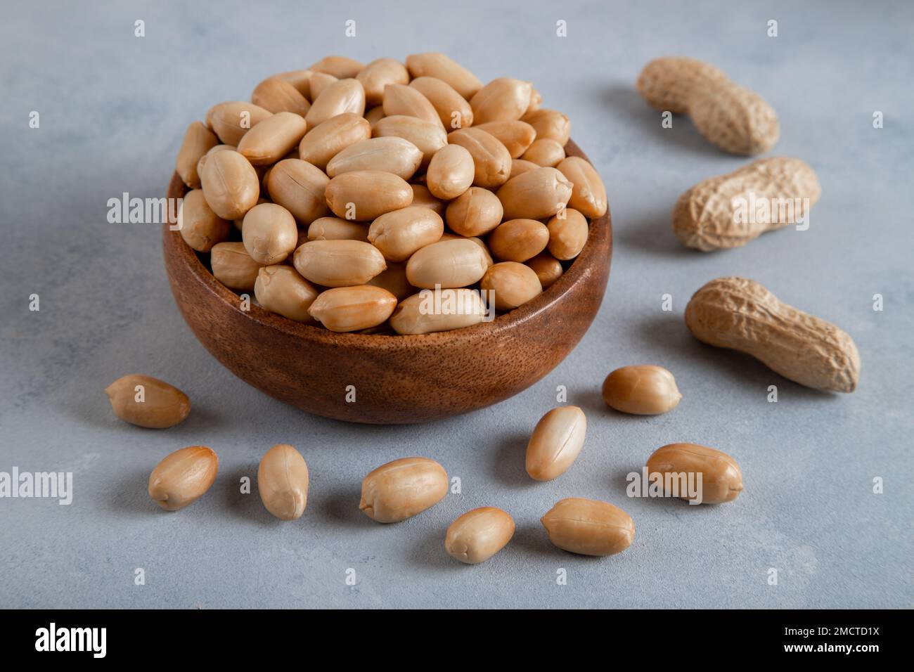 Bowl full of roasted peeled peanuts on bright background,closeup Stock ...