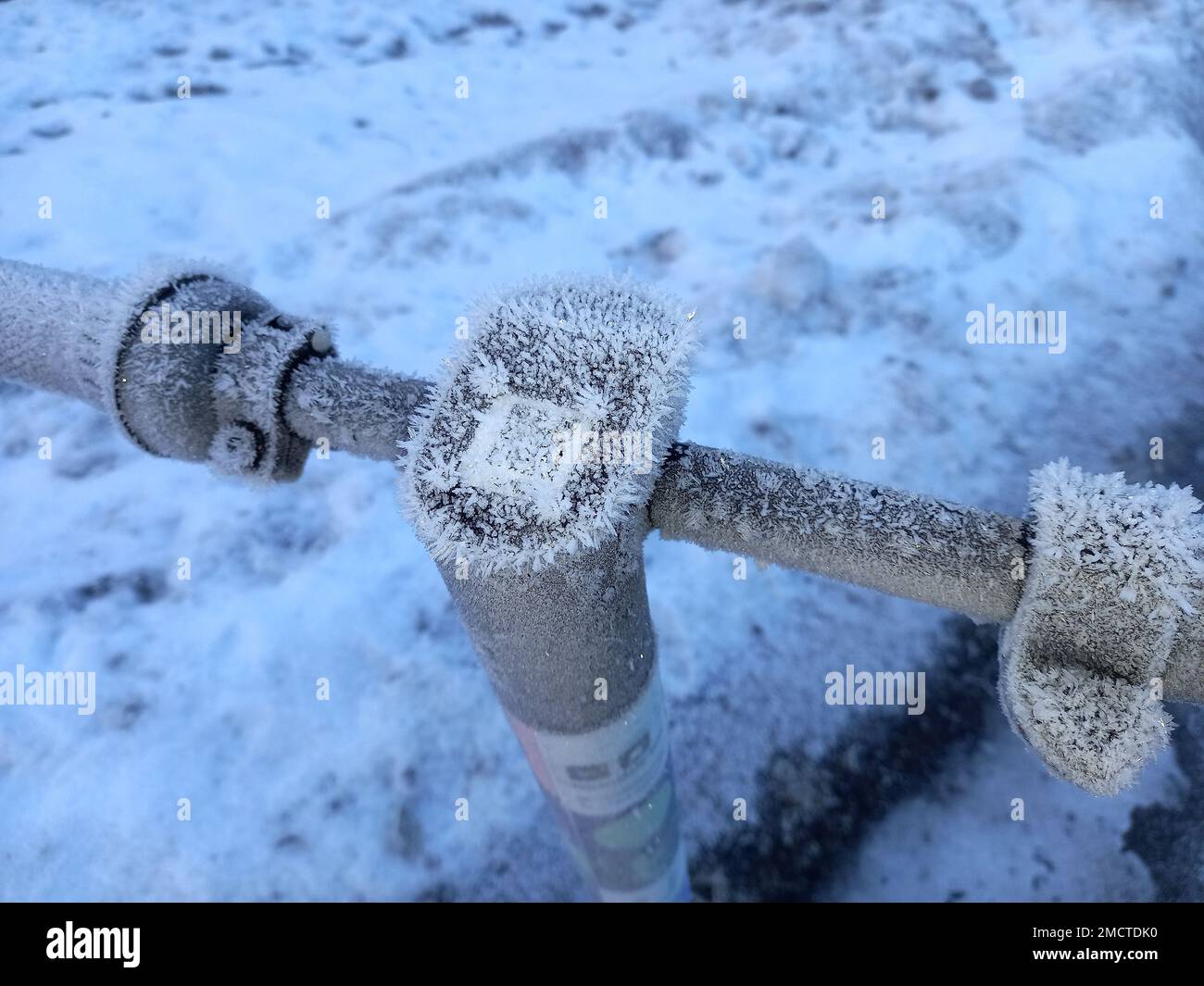 electric scooter QR code validating on freezing cold day covered with ...