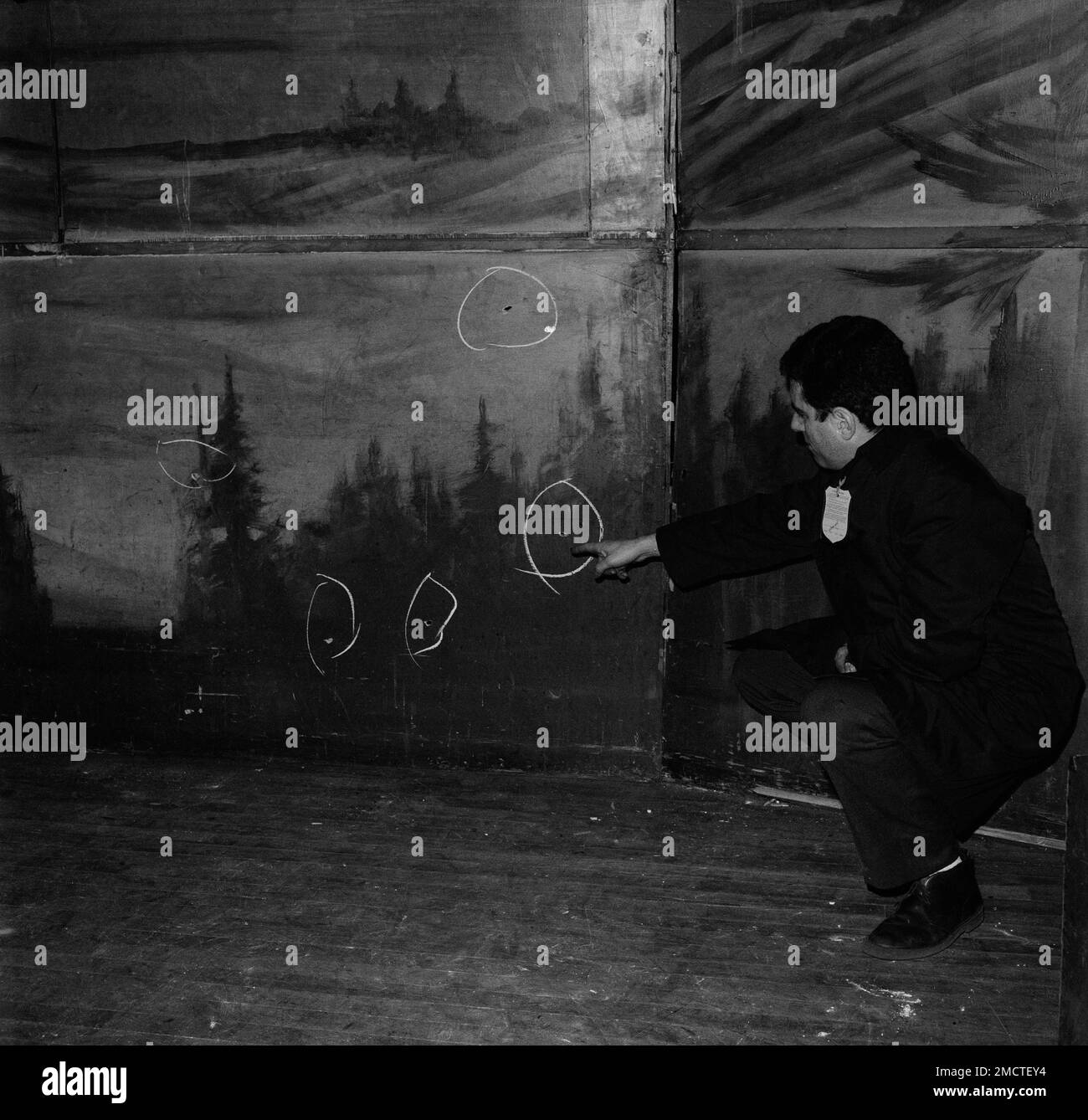 A official points to bullet holes in the podium behind which Malcolm X ...