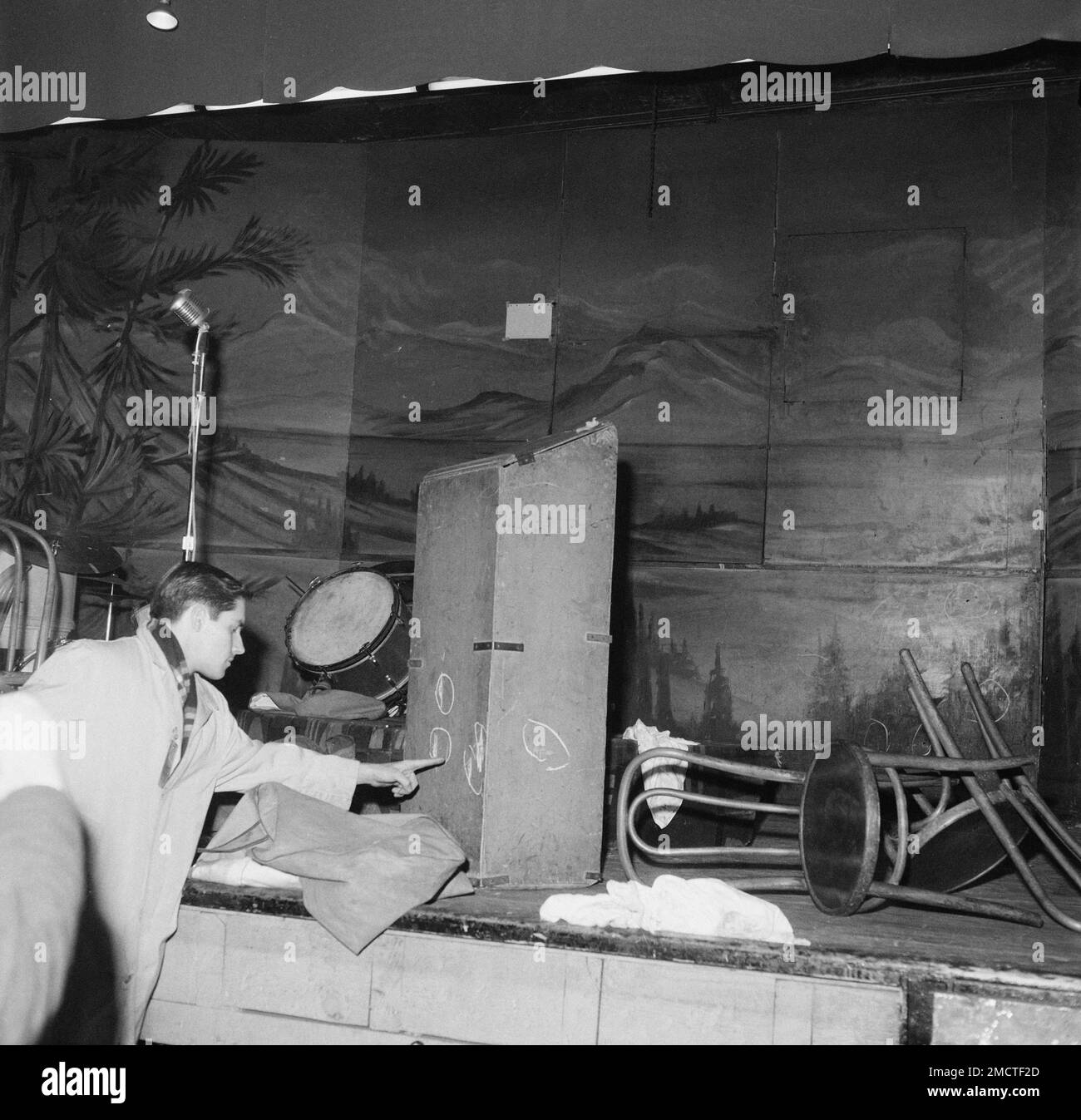 A man points to bullet holes in the podium behind which Malcolm X was ...