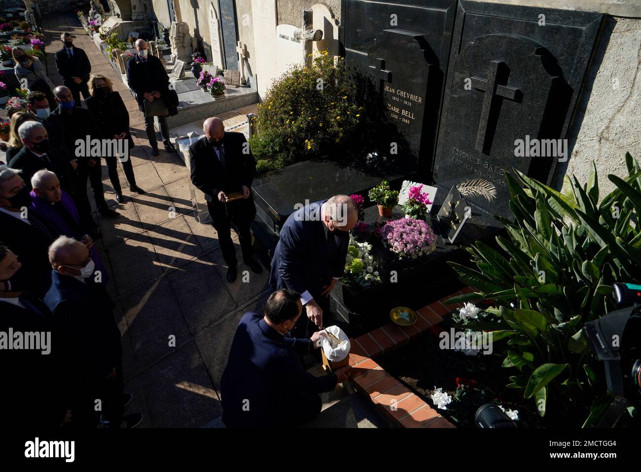 Prince Albert II of Monaco fills an urn with Monaco soil in front of ...