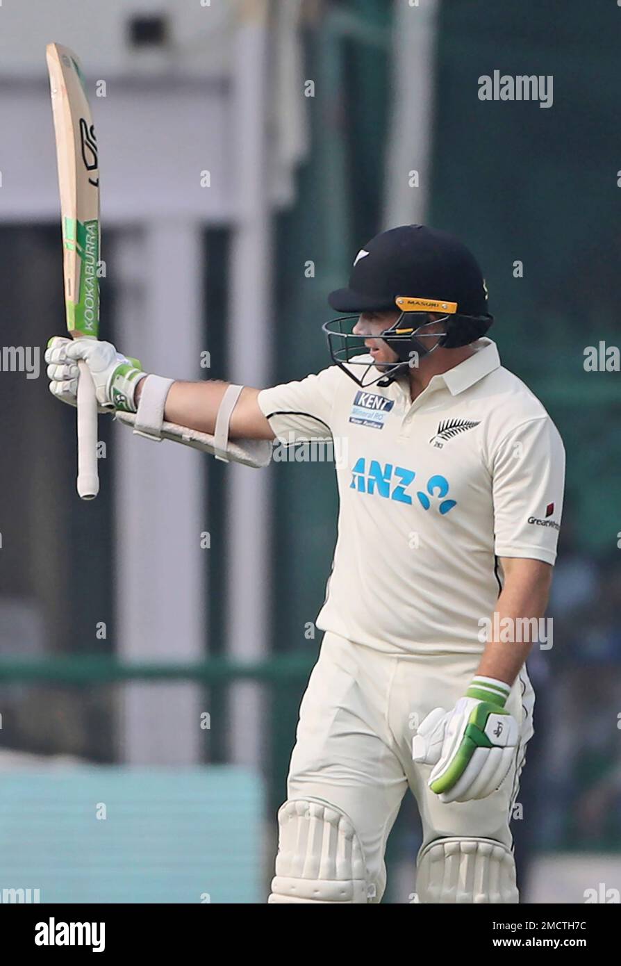 New Zealand's Tom Latham raises his bat after scoring fifty runs during ...