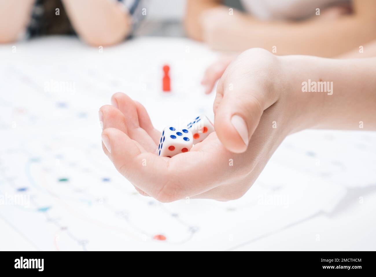 Cropped photo of group of children sitting at table, playing tabletop ...