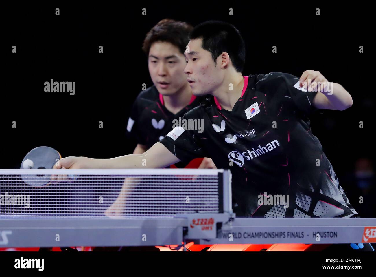 South Korea's Jonghoon Lim, left, looks on as Woojin Jang, right, returns a volley during a ...