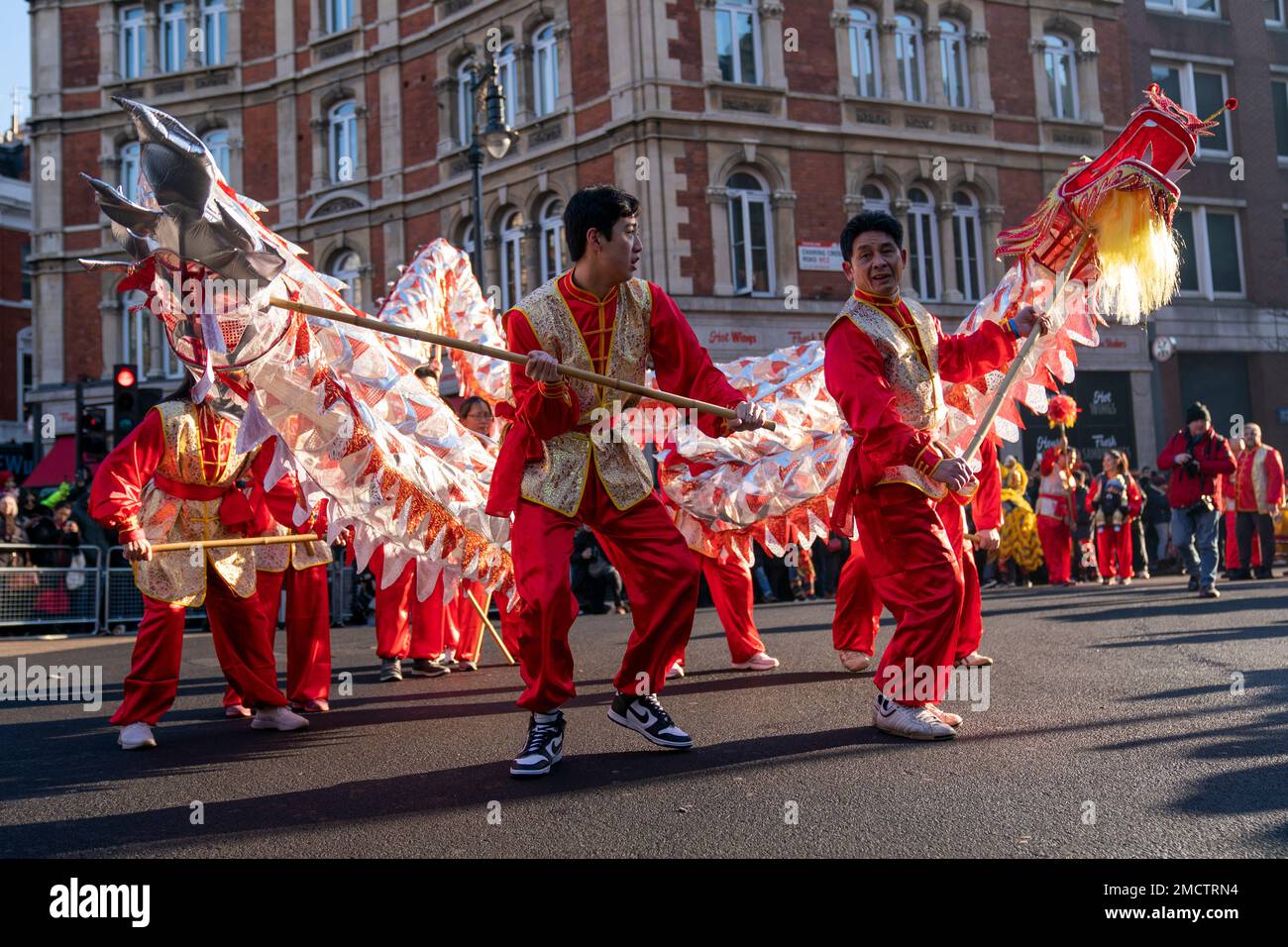 Performers taking part in a parade involving costumes, lion dances and ...