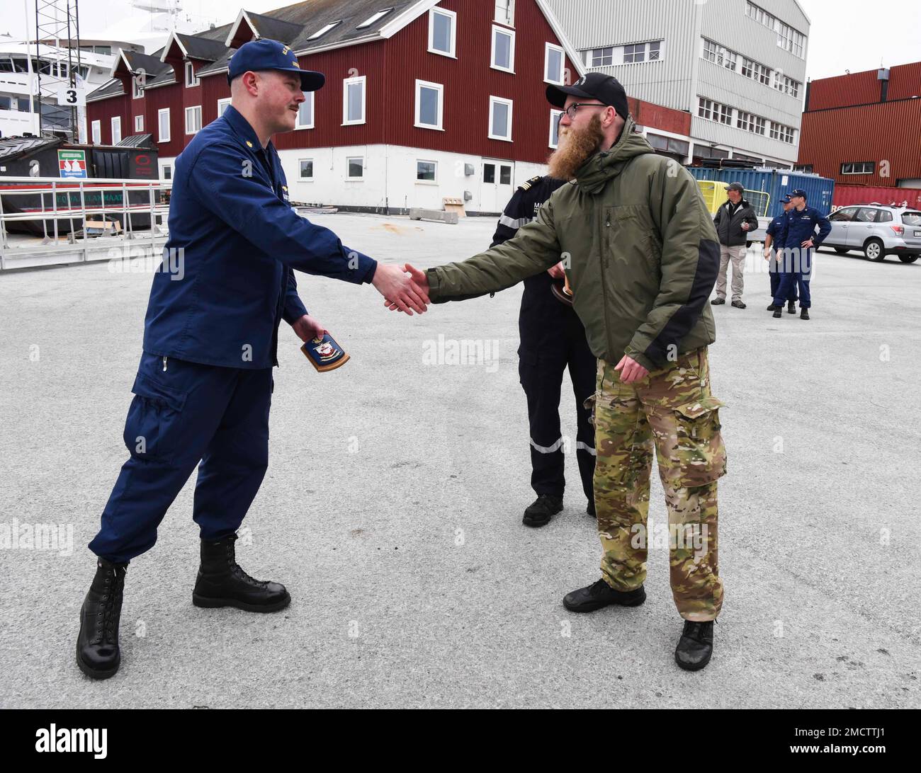 USCGC Oak (WLB 211) commanding officer Lt. Cmdr. Jacob Loman shakes ...