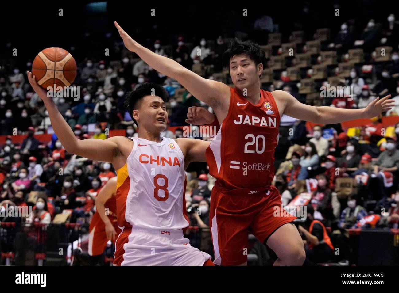 China's Zhao Rui, left, drives to the basket against Japan's Ryo Terashima during their FIBA ...