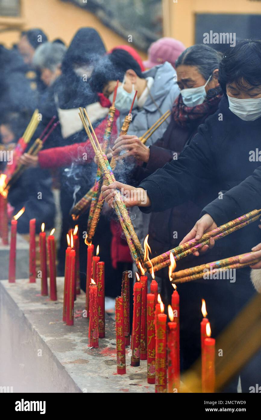 Fuyang, China. 22nd Jan, 2023. People burn incense and pray for good ...