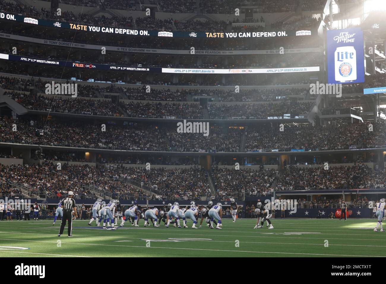 NFL action is seen in a general stadium view as light rays stream in ...
